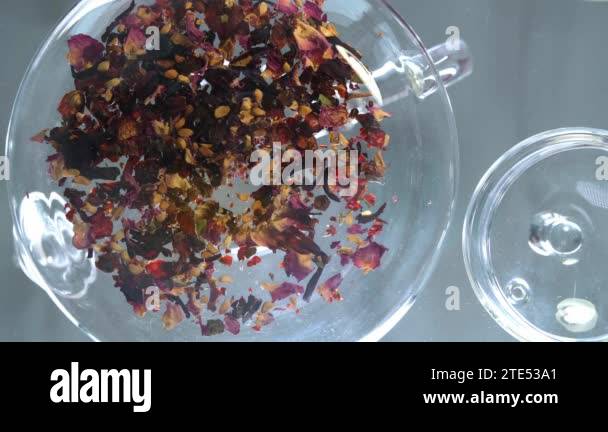 The process of making red tea. Hibiscus tea with rosehip seeds. Petals ...