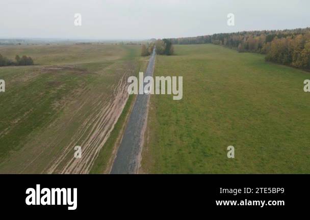 Aerial view of white electric car driving on countryside road. Modern ...