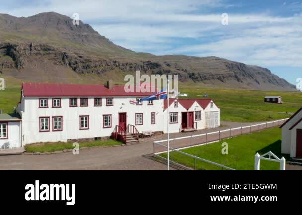 Icelandic national flag waving in wind in front of typical Nordic ...