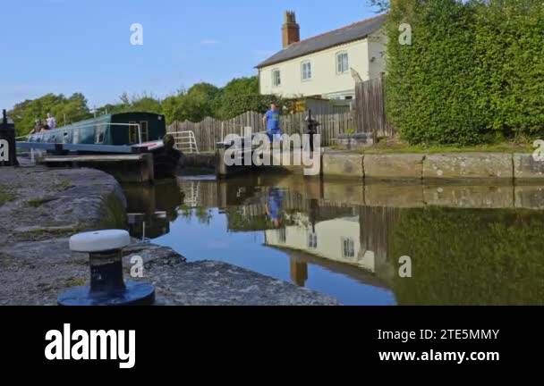 Strong men opening lock gates on Shropshire Union canal to allow hired ...