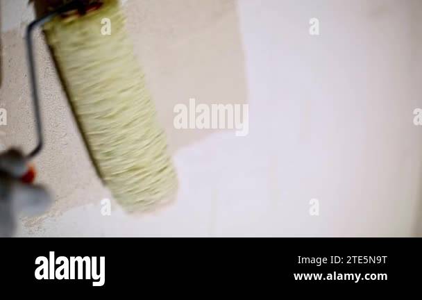 Applying a liquid primer coating a construction roller is preparation ...