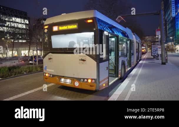 Electric bus ready to depart after charging battery. Pantograph ...
