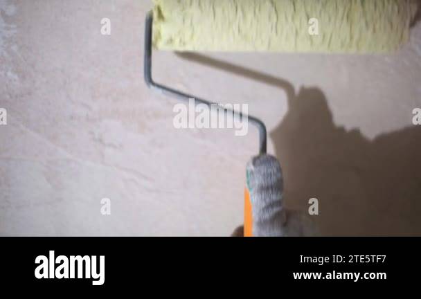 Applying a liquid primer coating a construction roller is preparation ...