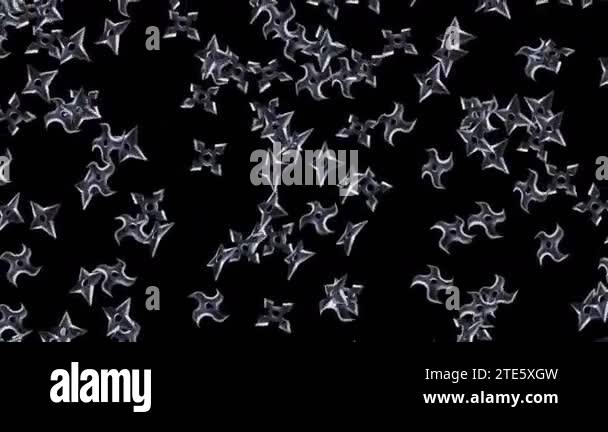 Many various shuriken throwing in air on black background. Japanese ...