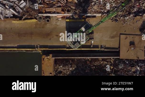 Aerial birds eye overhead top down footage of loader grabbing metal ...