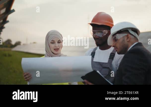 African american technician talking with muslim woman and indian man during working session on ...