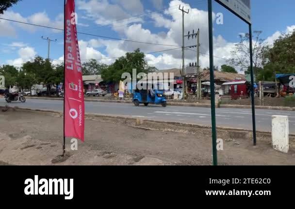 Arusha, Tanzania - December 27, 2021: Motorcyclists ride along one of ...