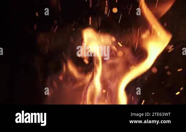 Fire burns down at night. Hot flame and sparks on black background in ...