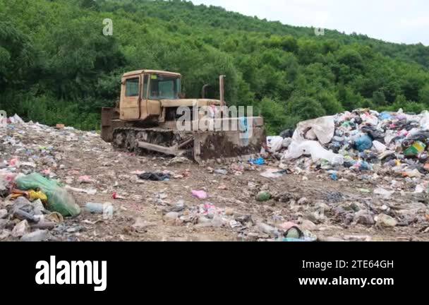 Old tractor at the landfill. The problem of plastic waste in the world ...