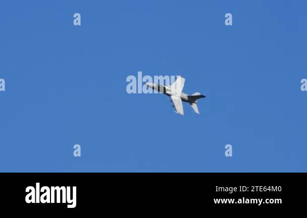 Ground attack aircraft in NATO grey color in flight in the blue sky ...