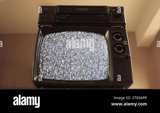 Male Hand putting VHS into VCR and an Old TV with Green Screen. You can ...