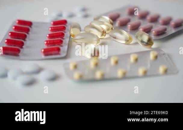 Close up of rotating pharmaceutical tablets and capsules in a blister ...