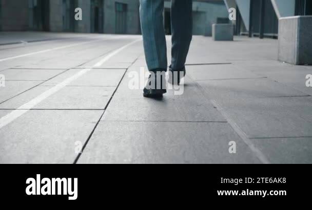 Back view of confident man in leather shoes and formal suit walking ...