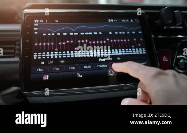 Man finger changing car audio equalizer settings using smart multimedia ...