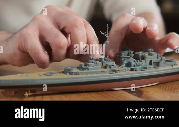 Happy adult male assembler plastic model of warship according to ...