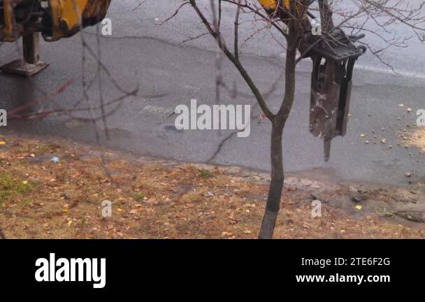 Tractor with hydraulic hammer ready for demolition work with asphalt ...