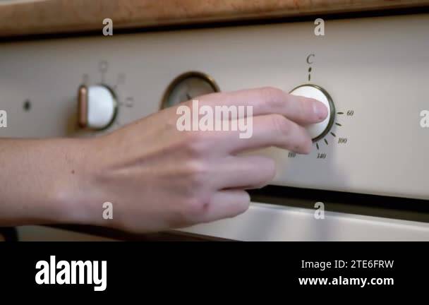 A Female Hand Sets the Time, Mode, Cooking Temperature on a Modern Oven ...