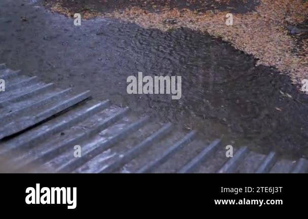 Rain Drops Flow Down, Fall from the Roof in a Puddle During Pouring ...