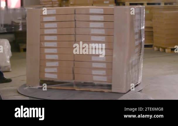 Packaging boxes with products in plastic film at the factory. A special ...