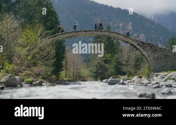 8K 7680X4320 4320p.People walking on the historical stone arch bridge ...
