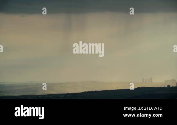 8K 7680x4320.Rain in front of a sunny background.Storm clouds are ...