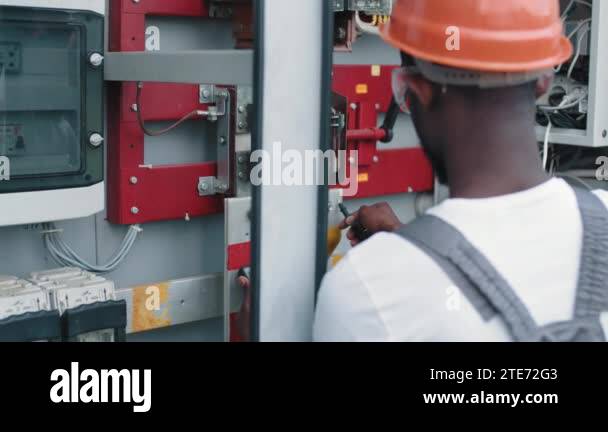 Close up of man using multimeter for work on solar station. African ...
