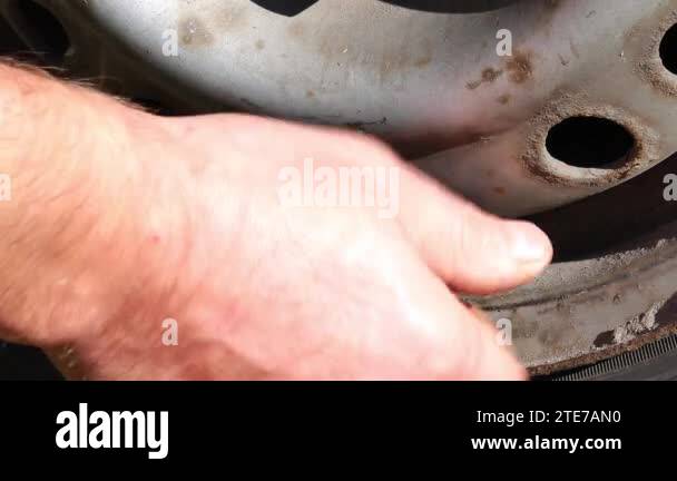 Connecting the pumping hose of the car wheel. Car wheel valve. Air pump ...