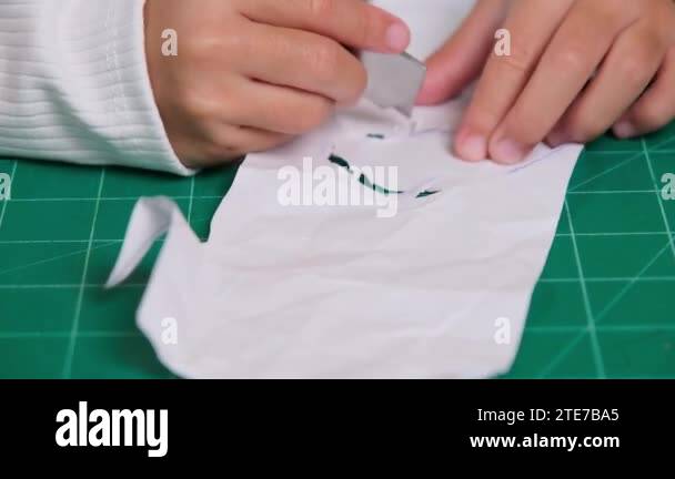 Little girl cutting paper with cutter knife alone, playing with sharp ...