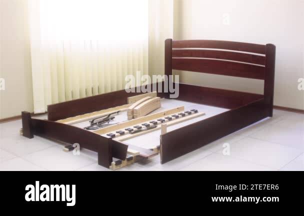 installation of a double wooden bed with a transforming frame Stock ...
