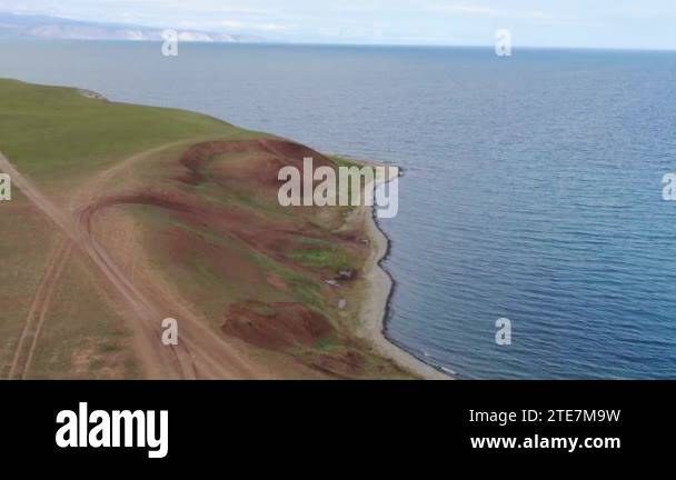 Cinematic aerial view of the high mountains of Siberia. The famous Lake ...