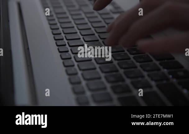 In the dark, the hackers hands work on the keyboard. Cyber crimes. A ...