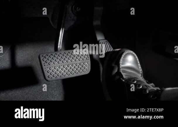 Accelerate and Brake. Foot pressing foot pedal of a car to drive ahead ...