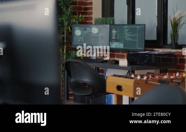 Desk With Multiple Computer Monitors Displaying Neural Network