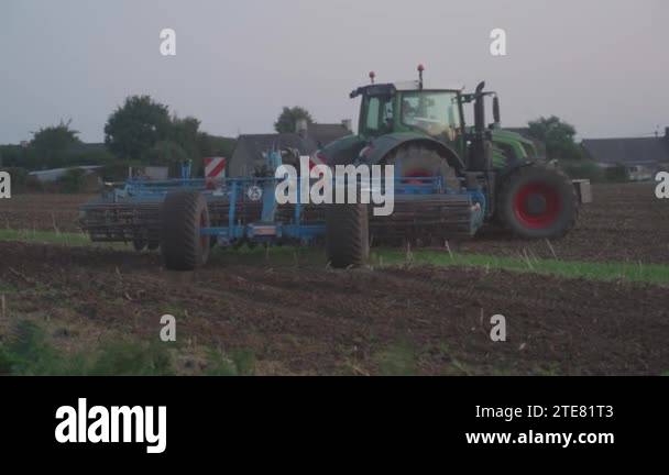 Harvesting machine works in a field in northern France in the Brittany ...