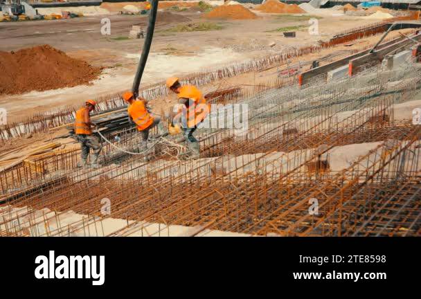 Working process at a construction site. Workers make a reinforced ...