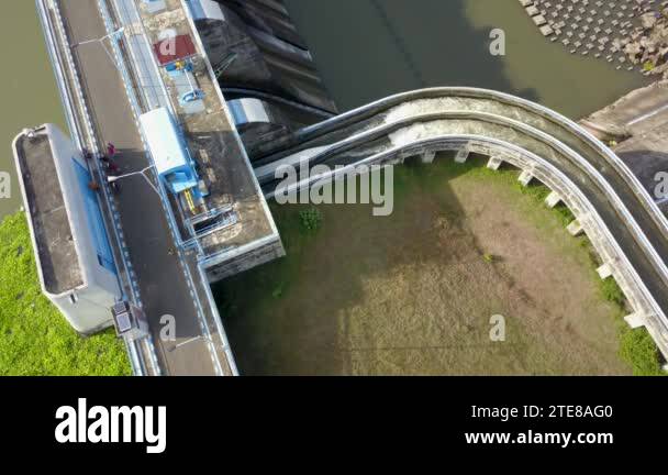 Water in dam concrete spillway infrastructure at reservoir. Waterfall ...
