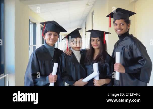 Indian university graduates stand in front of the camera in masters ...