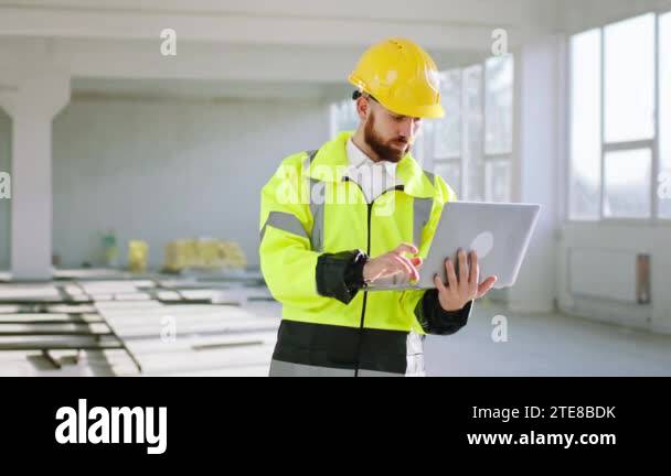 Charismatic engineer man at construction site in a special uniform ...
