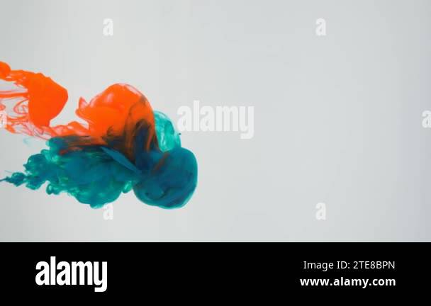 Mixing of blue and red colors on a white background. Injection of ...