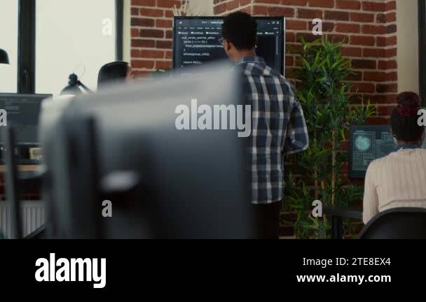 Team Of Coders Analyzing Code On Wall Screen Tv Comparing Errors Using 8208