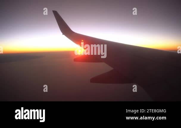 Sunrise from porthole plane, wing view from airplane window, silhouette ...