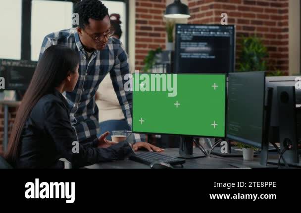 Mixed team of programmers analyzing source code looking at green screen chroma key mockup Stock ...