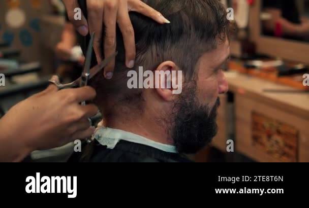 Professional barber shaves customer beard with straight razor. Beard ...
