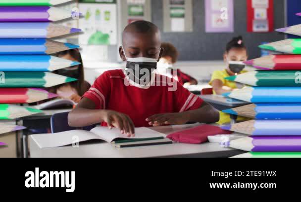 Animation of crayons over diverse schoolchildren wearing face masks ...