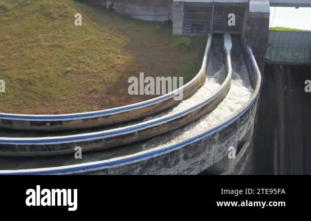 Aerial water in dam concrete spillway infrastructure at reservoir ...