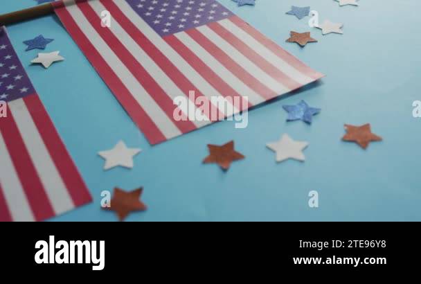 American flags with red and blue stars lying on blue background ...