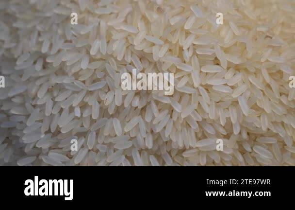 Full frame background of raw white rice rotating on turn table. View ...