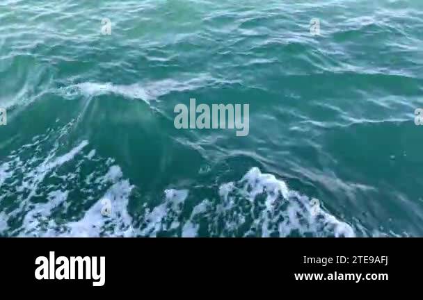 The flow of water overboard a seagoing vessel. Splashes and movement of ...