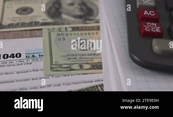 IRS form 1040 with individual income tax return of dollar bills of ...