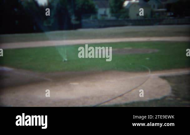 Watering the residential neighborhood baseball field diamond Stock ...